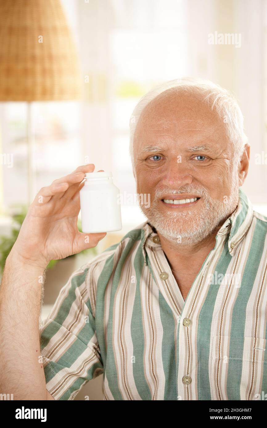 Older man presenting medication Stock Photo - Alamy