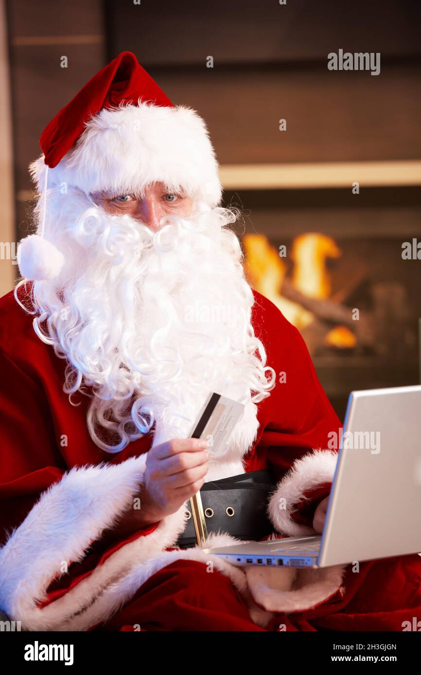 Santa Claus paying with credit card Stock Photo - Alamy