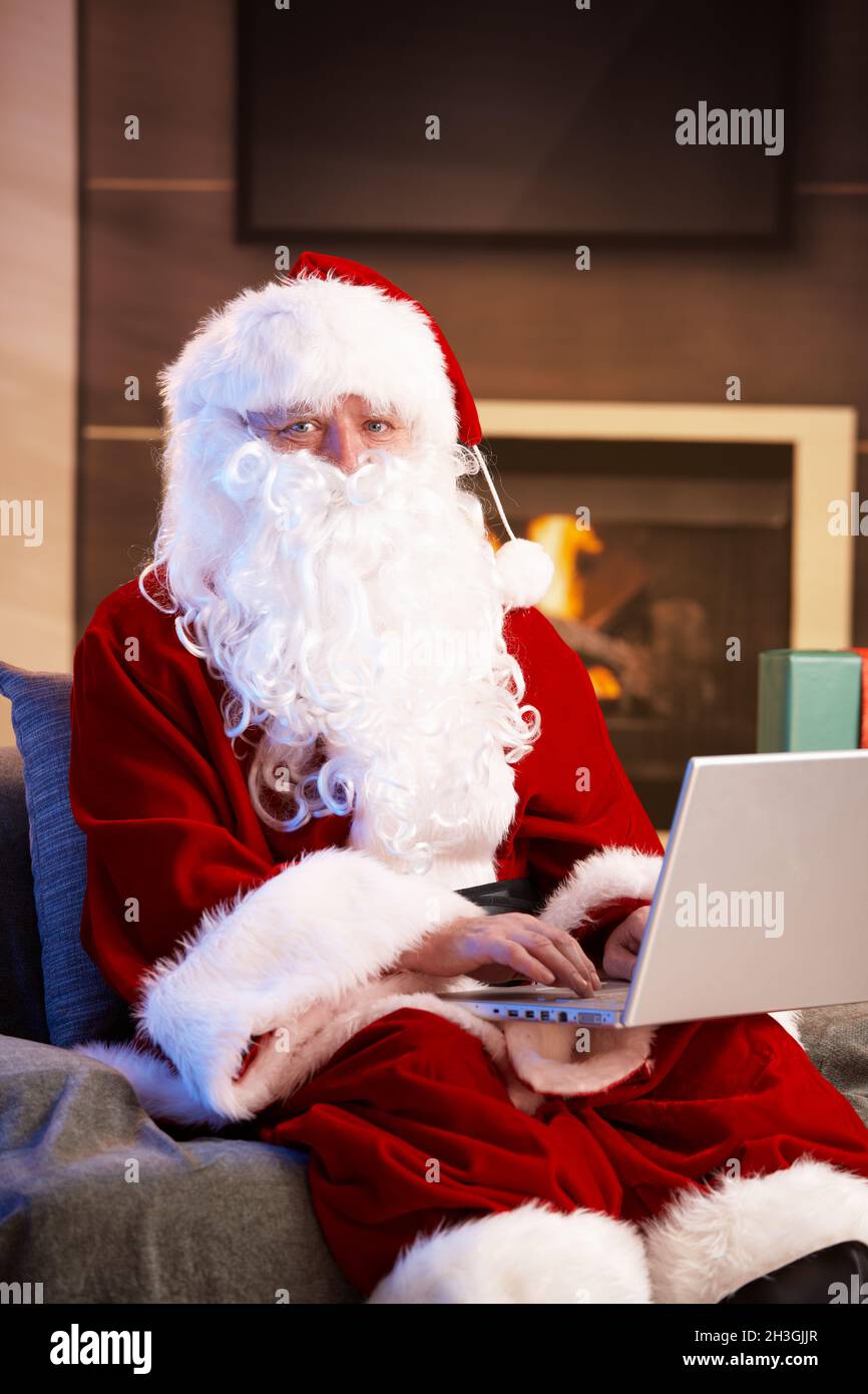 Santa using computer Stock Photo - Alamy