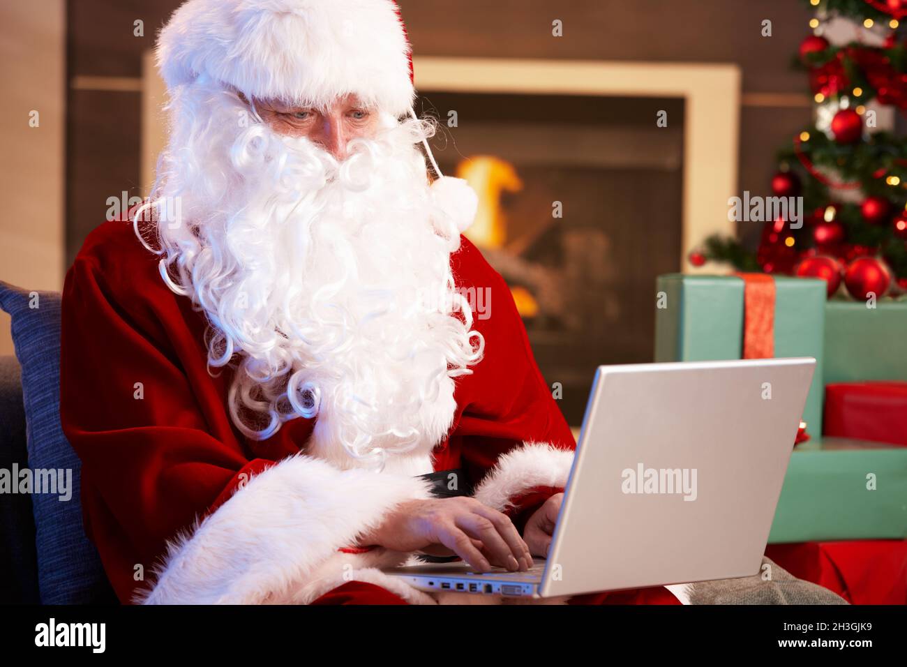 Santa using computer Stock Photo - Alamy