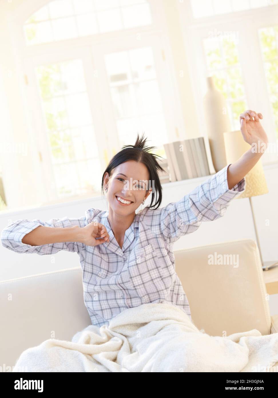 Woman alone happy stretching couch hi-res stock photography and images ...