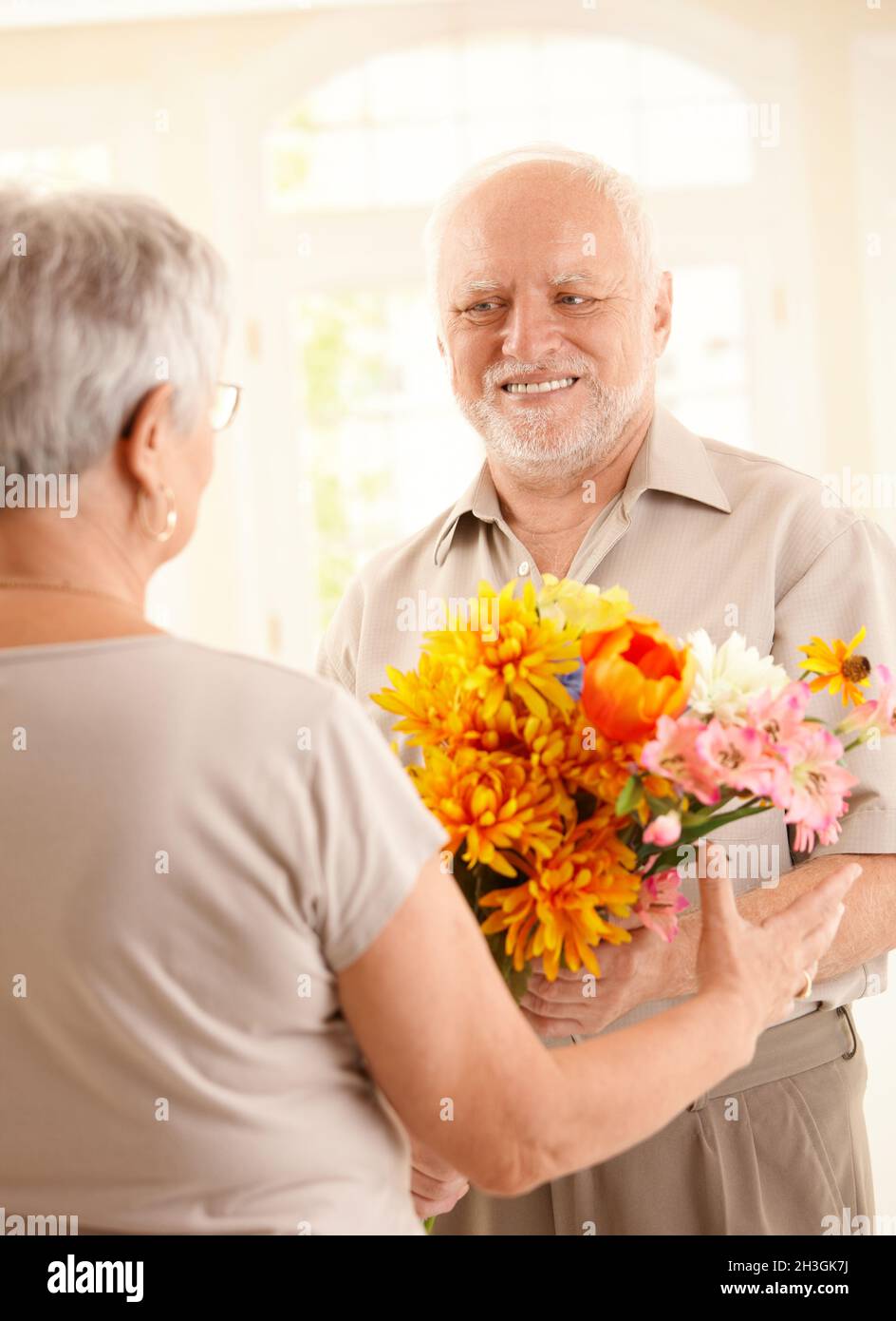 Elderly man bringing woman flowers hi-res stock photography and images ...