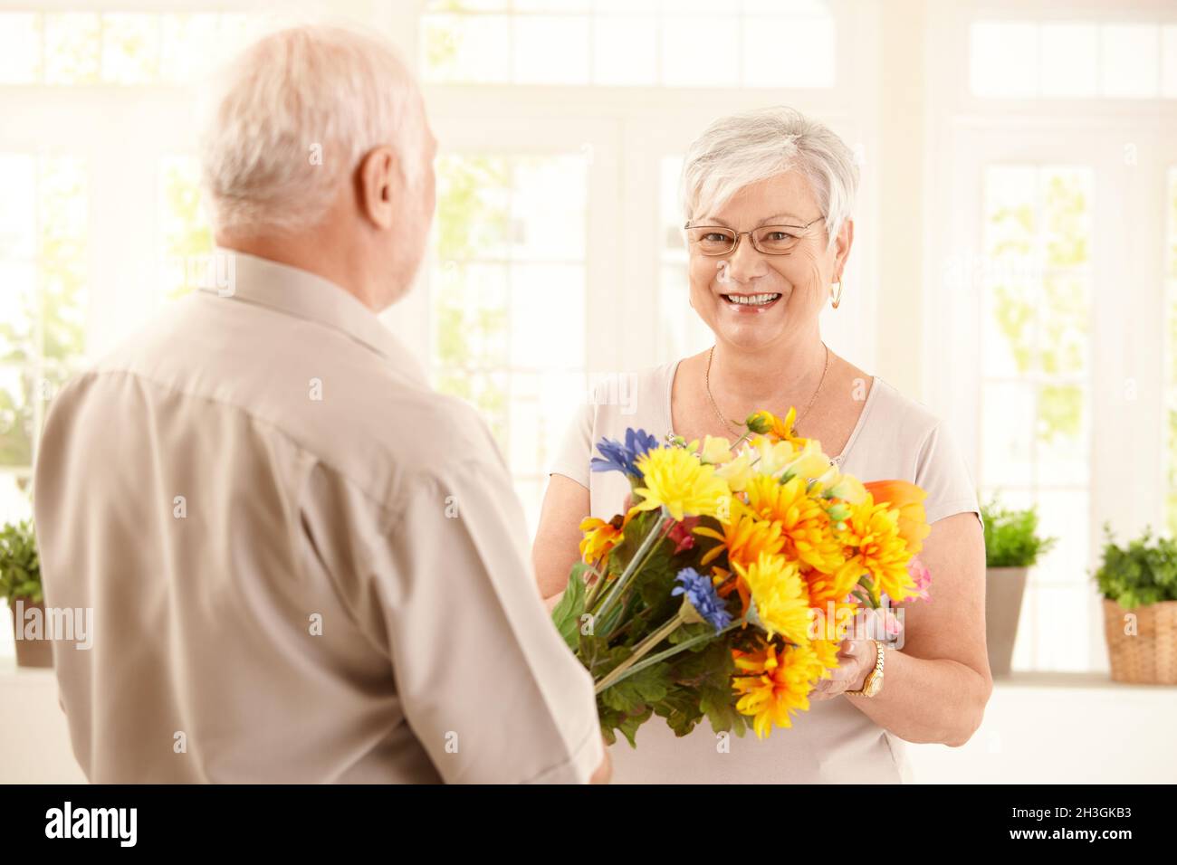 Happy elderly woman getting flowers Stock Photo - Alamy
