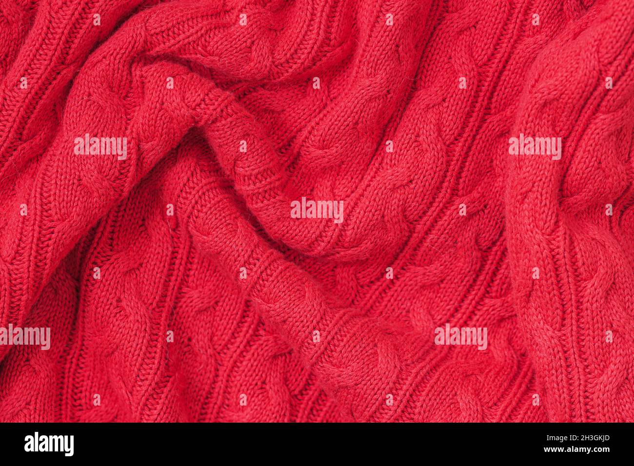 Handmade knitwear, knitted texture with a pattern, bright red color ...