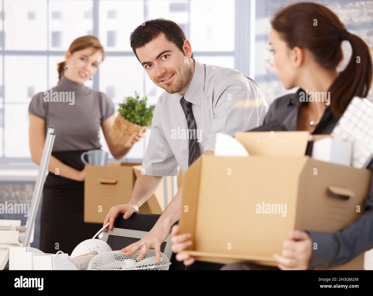 Young group of office workers moving to new office Stock Photo - Alamy