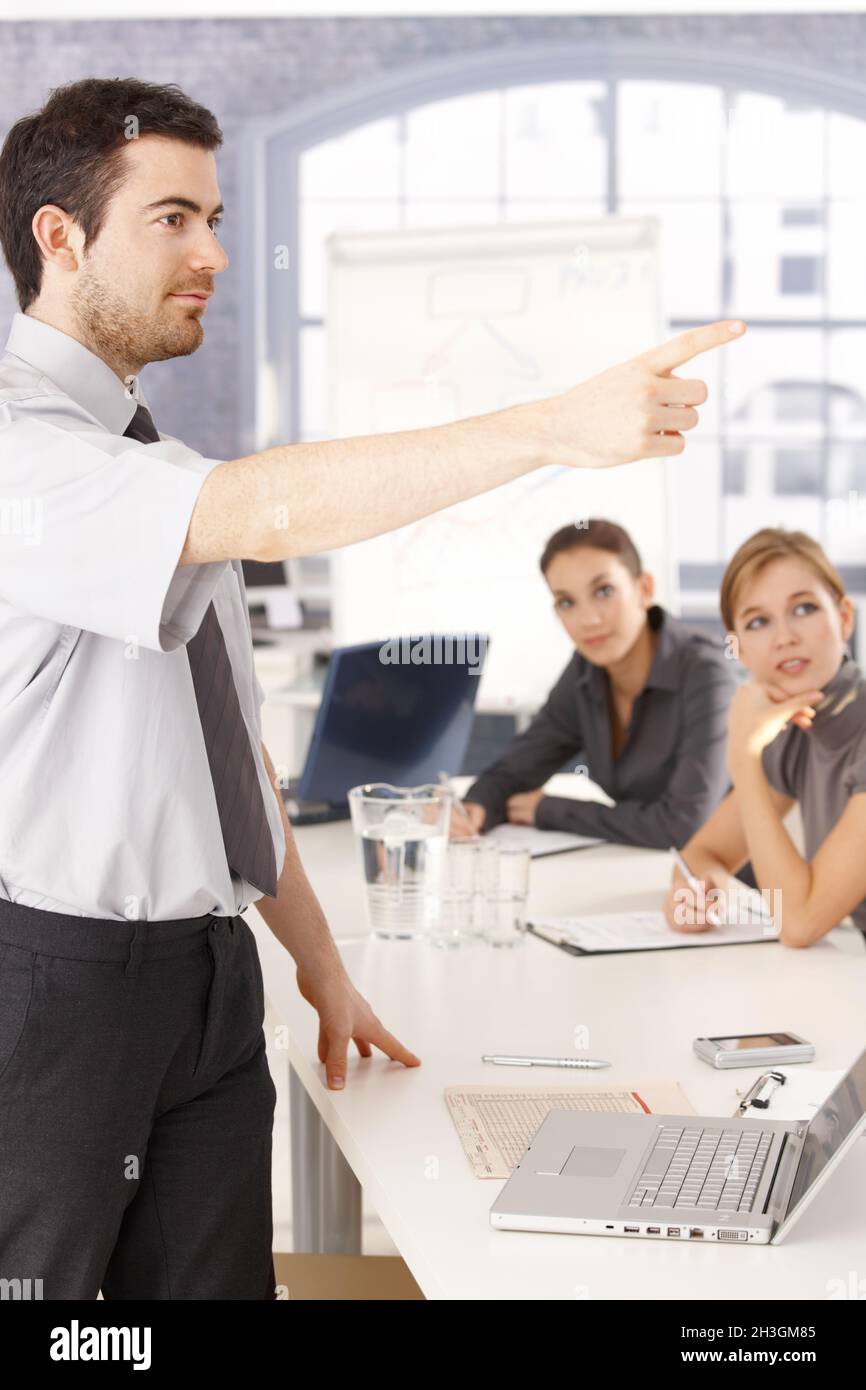 Young man presenting in meeting room Stock Photo - Alamy