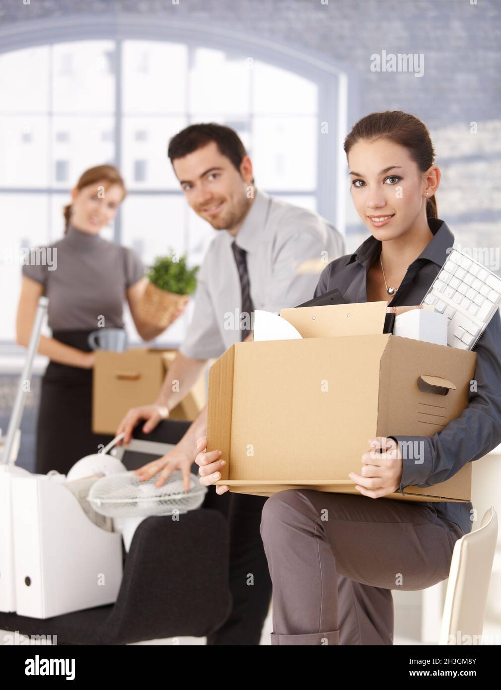 Happy businesspeople moving to new office Stock Photo - Alamy