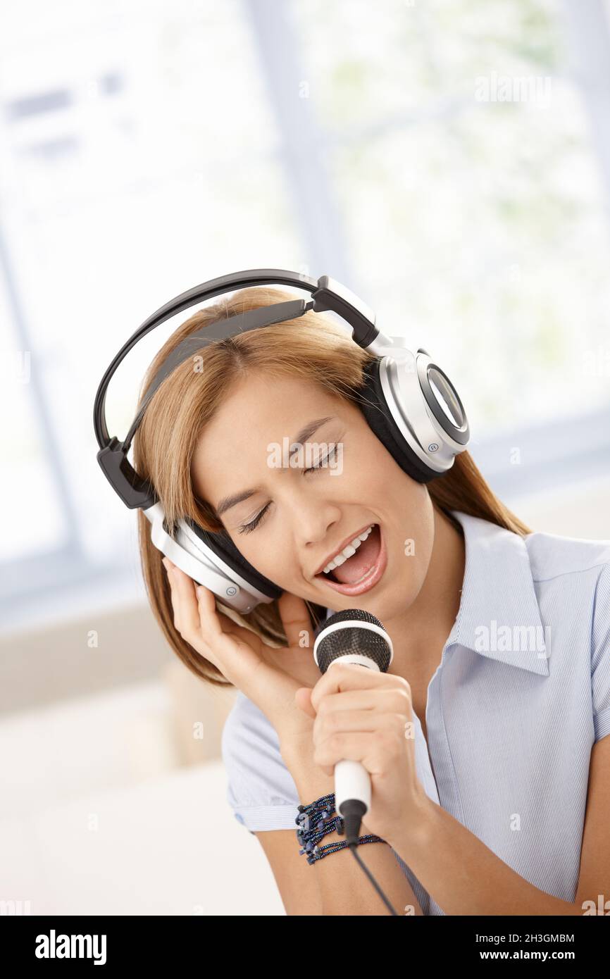 Attractive girl singing eyes closed Stock Photo - Alamy