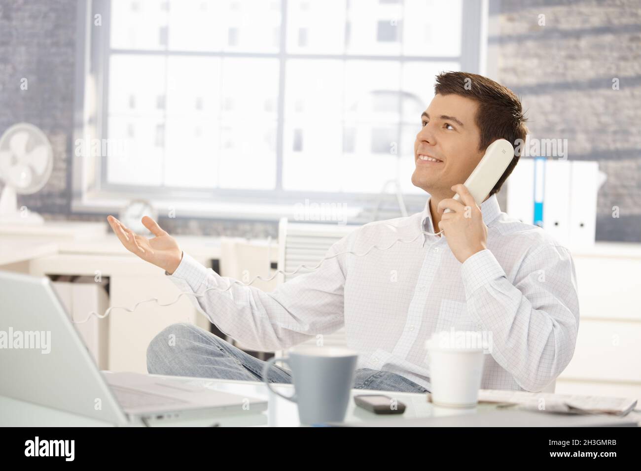 Businessman in office on phone call Stock Photo - Alamy