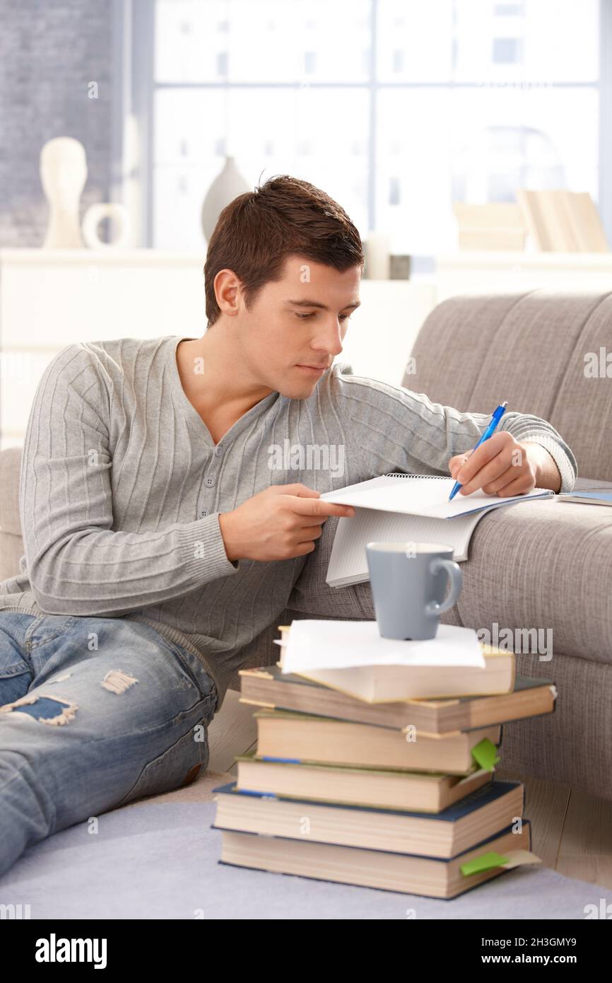 University student writing notes at home Stock Photo - Alamy