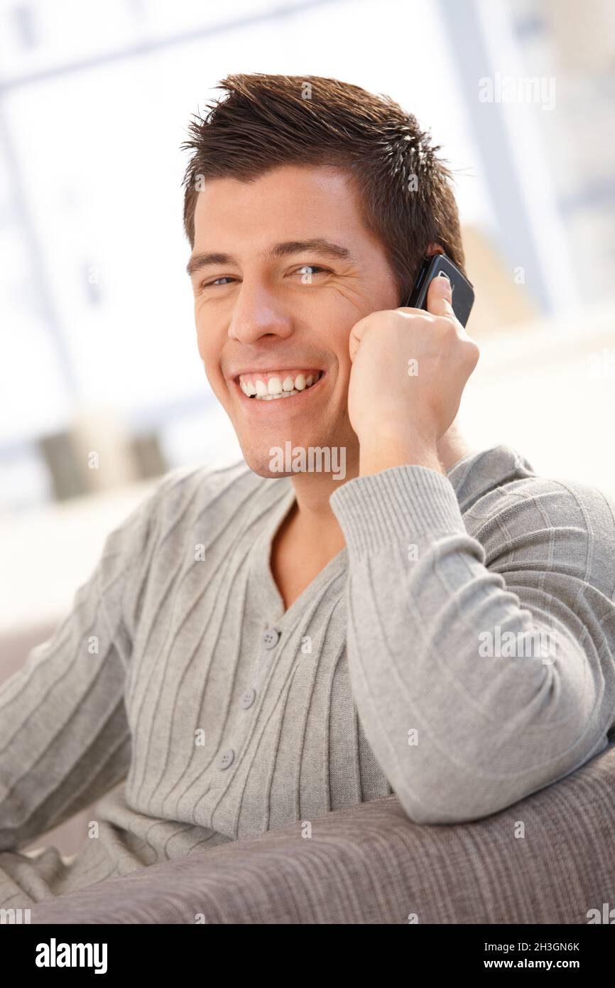 Portrait of laughing guy speaking on cellphone Stock Photo - Alamy
