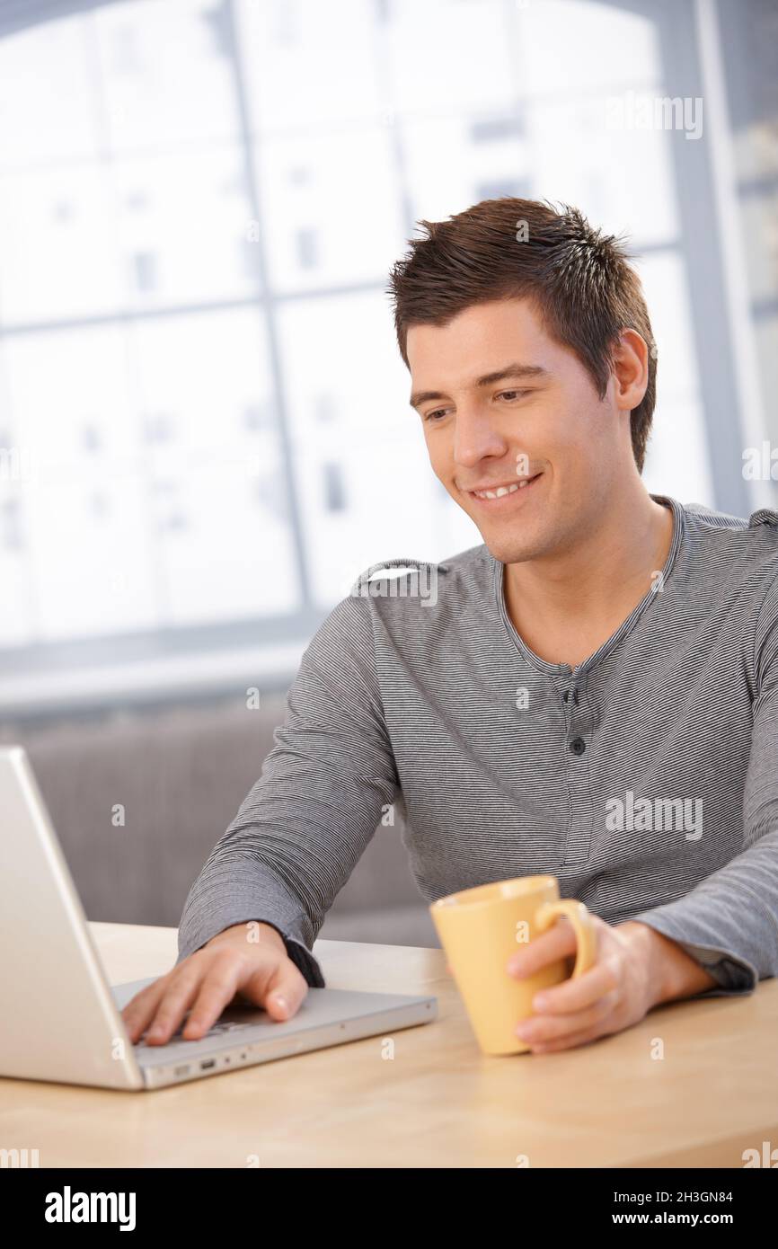 Young guy with laptop hi-res stock photography and images - Alamy