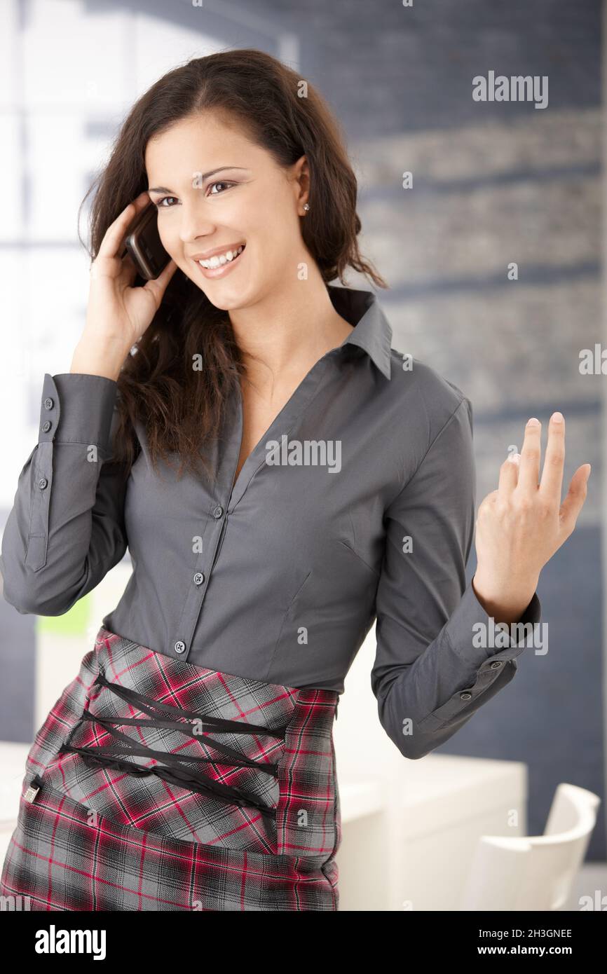 Happy office worker using mobile smiling Stock Photo - Alamy