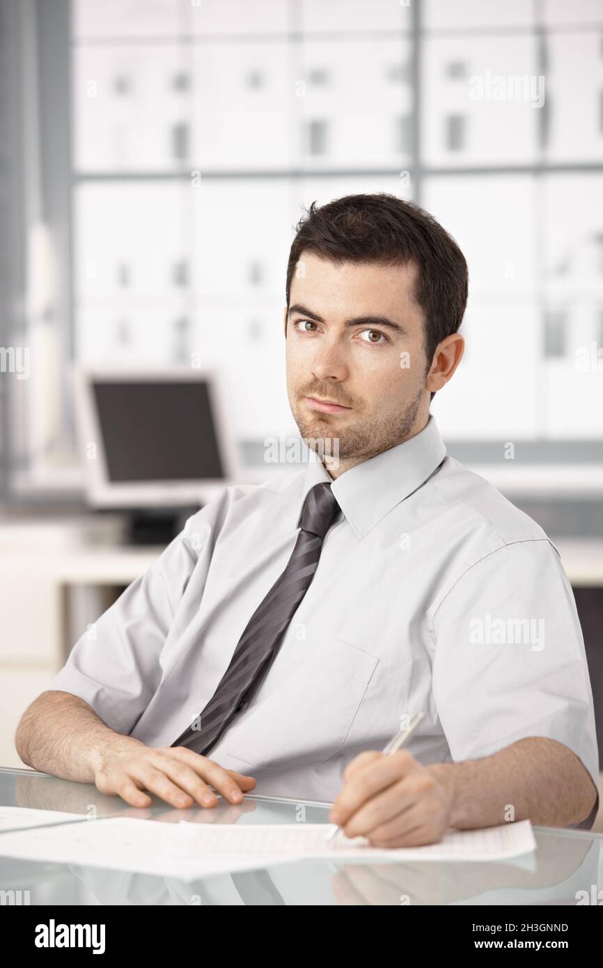 Man sitting desk writing in hi-res stock photography and images - Alamy