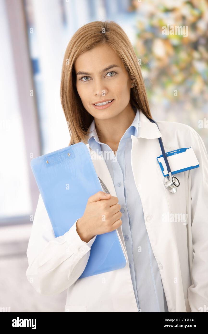 Attractive female doctor smiling Stock Photo - Alamy