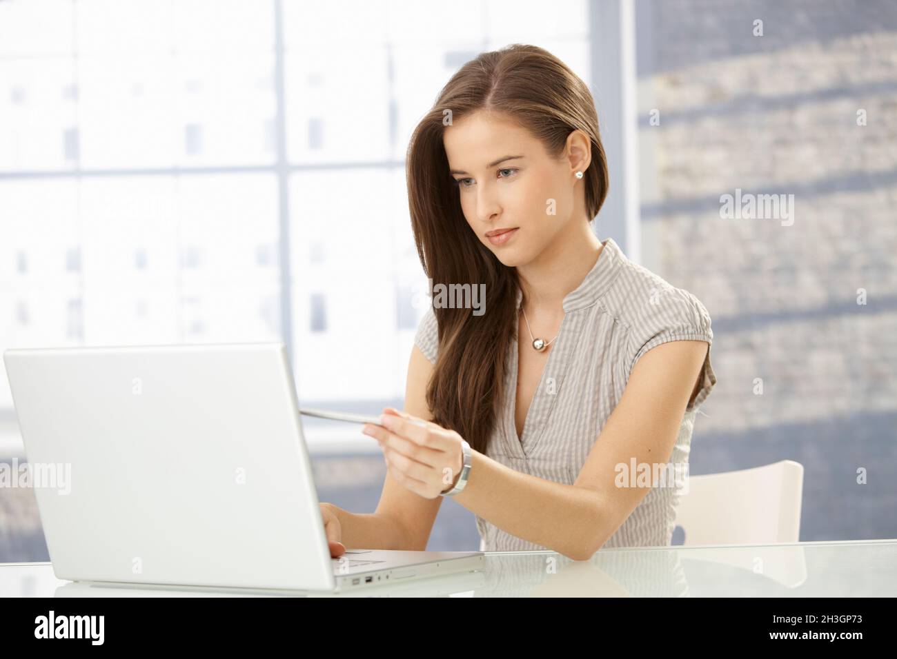 Office worker girl reading on screen Stock Photo - Alamy