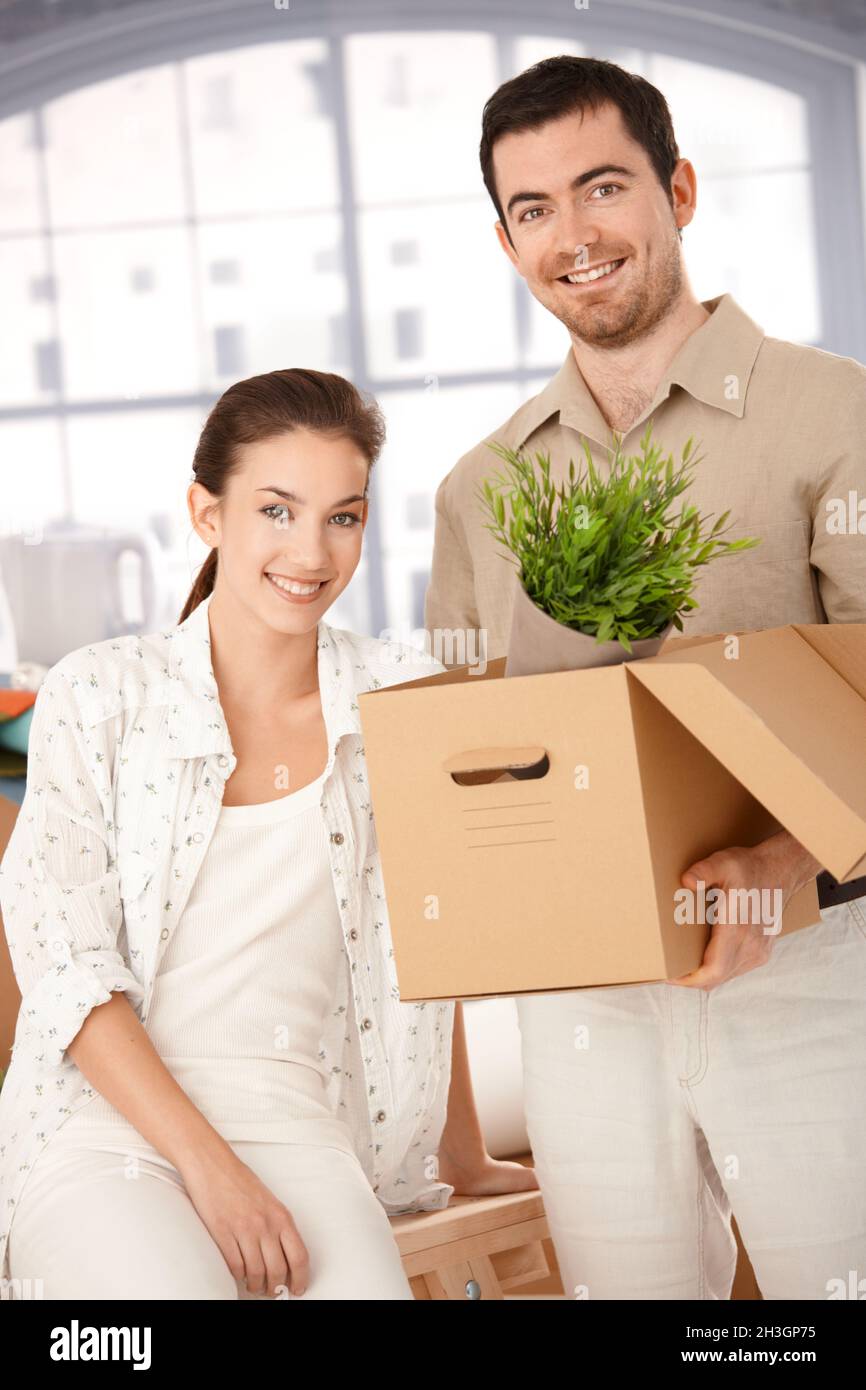 Happy couple unpacking boxes in new home Stock Photo - Alamy