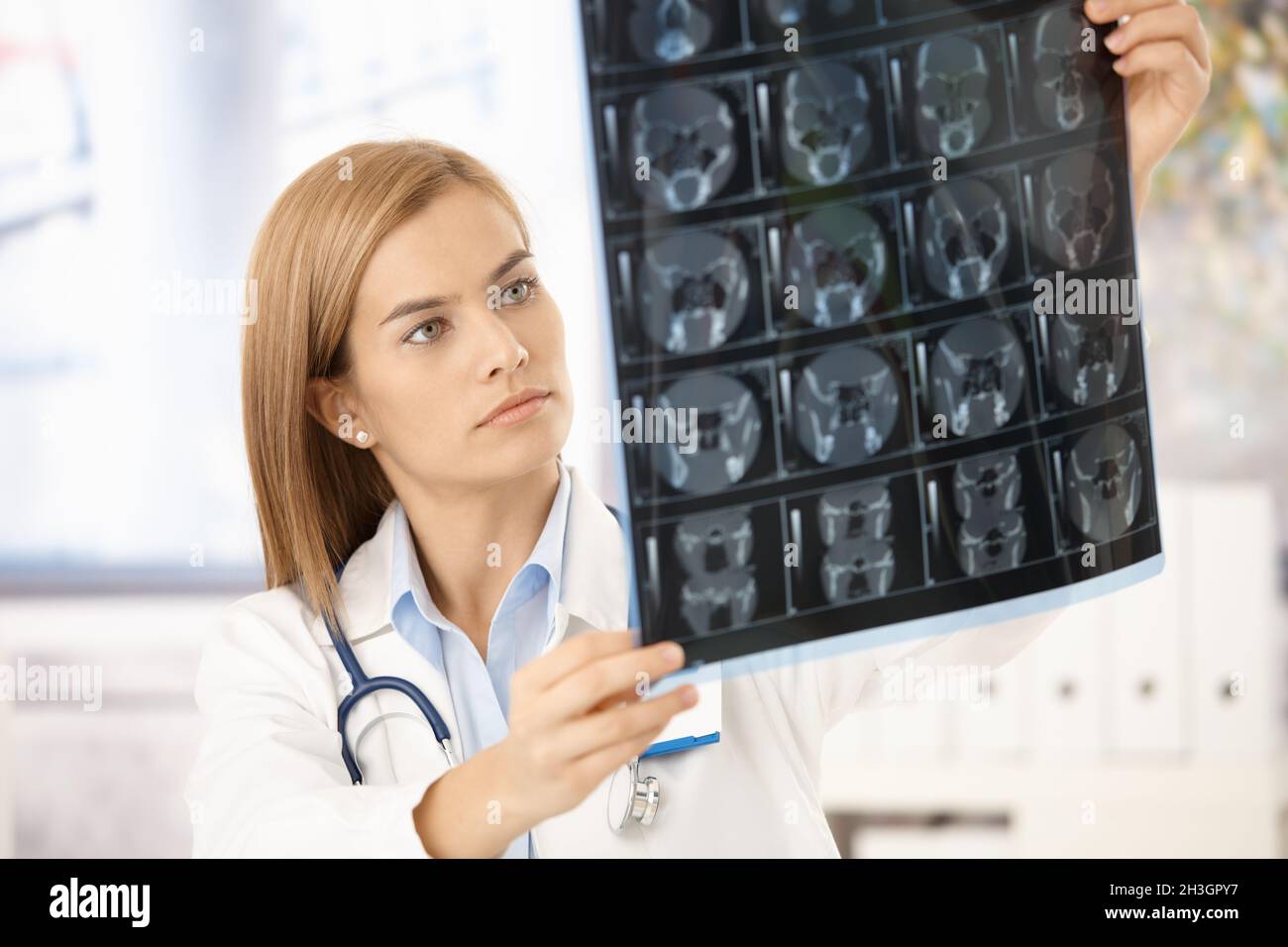 Young radiologist looking at x-ray image Stock Photo - Alamy