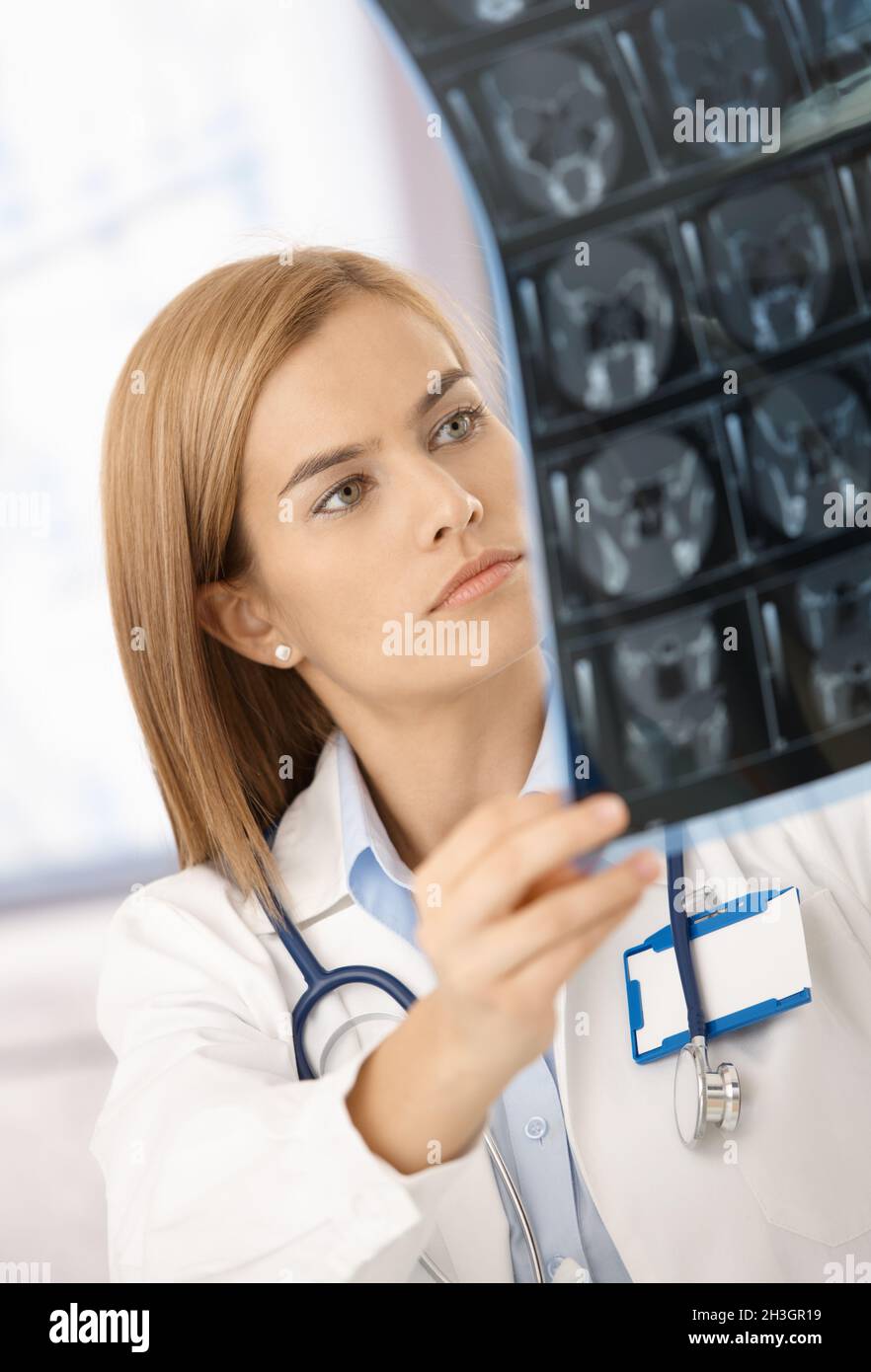 Attractive radiologist analysing x-ray image Stock Photo - Alamy