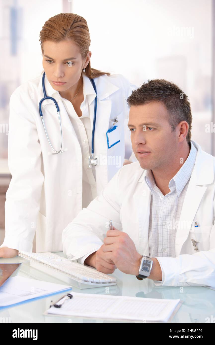 Young doctors working together in office Stock Photo - Alamy
