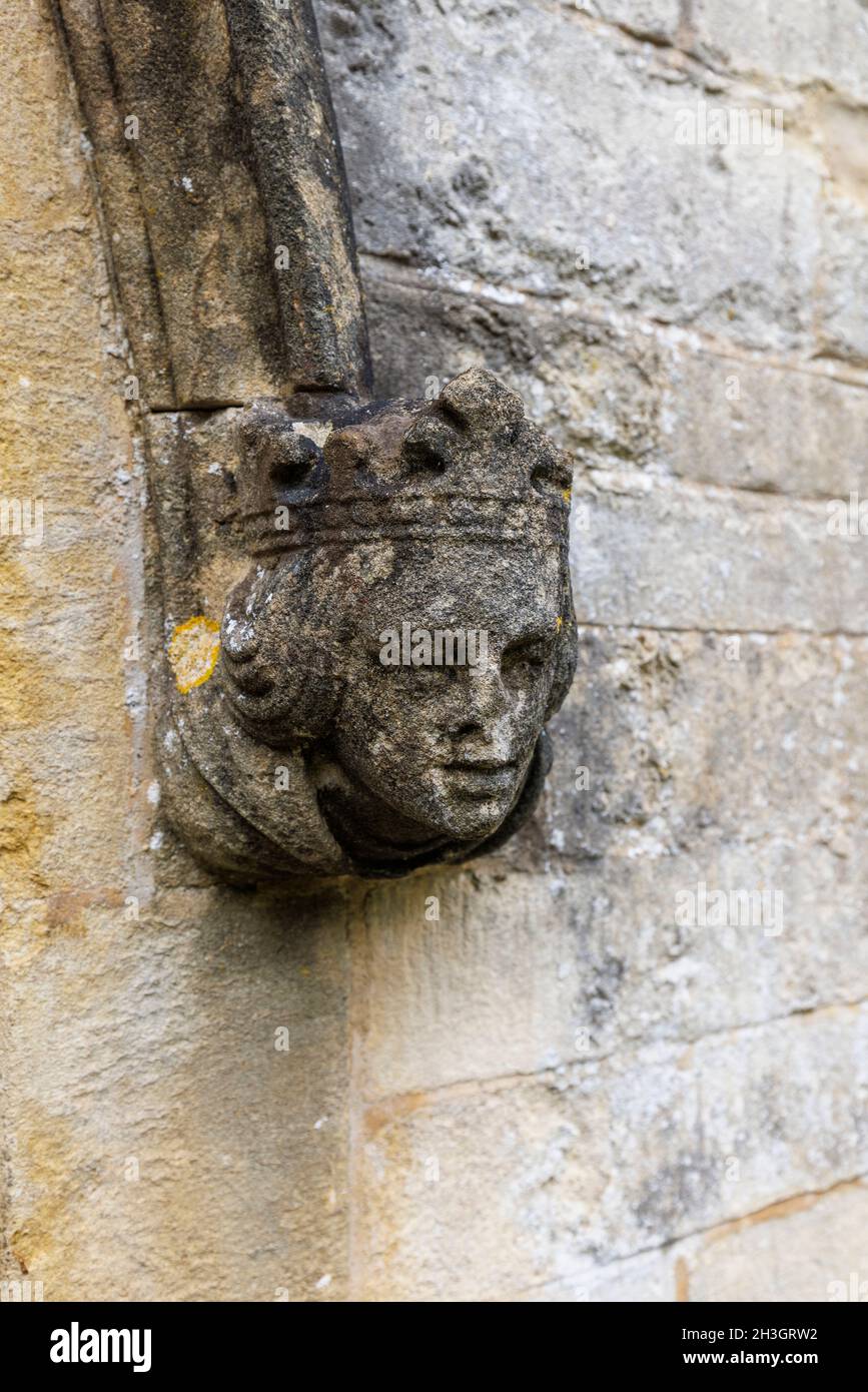 Weathered carved stone figure head, St Andrew's Church, Castle Combe, a ...