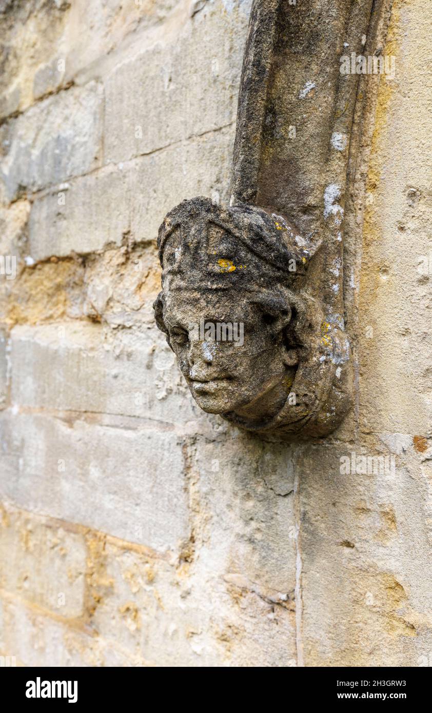 Weathered carved stone figure head, St Andrew's Church, Castle Combe, a ...