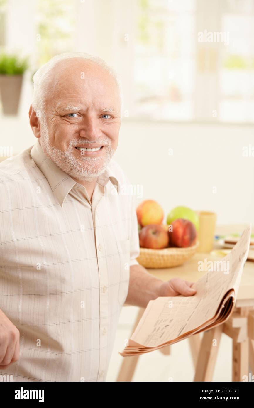 Portrait smiling man sitting breakfast table newspaper hi-res stock ...
