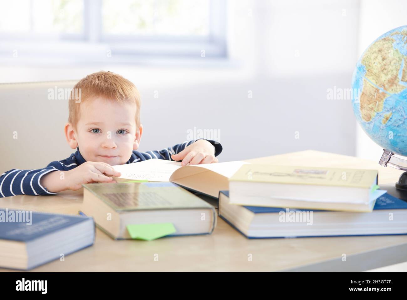 Little child prodigy learning at home smiling Stock Photo - Alamy