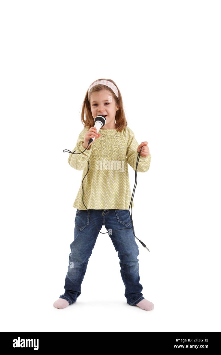 Little girl singing with microphone Stock Photo - Alamy