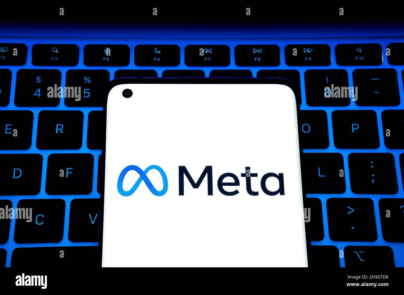 Facebook META company logo seen smartphone which is placed on laptop ...