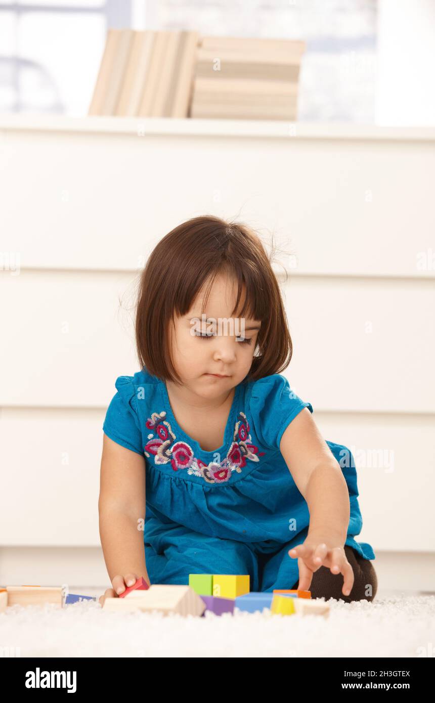 Small girl with building block Stock Photo - Alamy