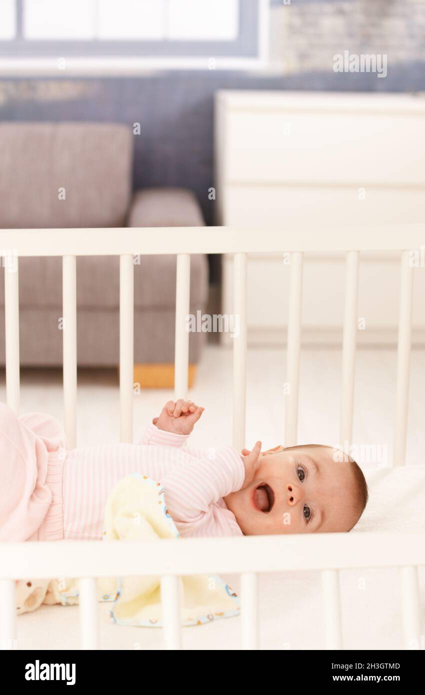 Cute baby lie in crib hi-res stock photography and images - Alamy