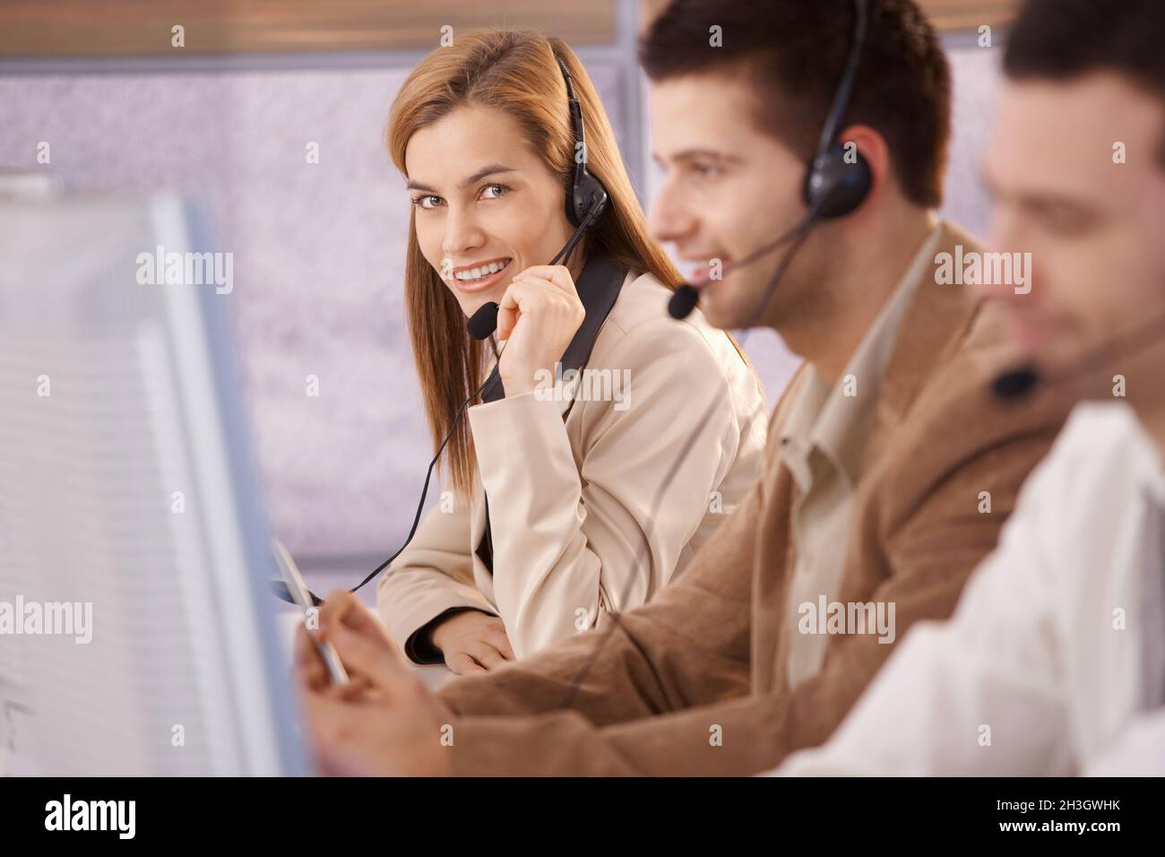 Pretty female dispatcher in call center smiling Stock Photo - Alamy