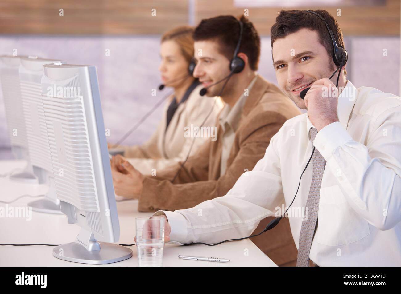 Cheerful customer servicer working in call center Stock Photo - Alamy
