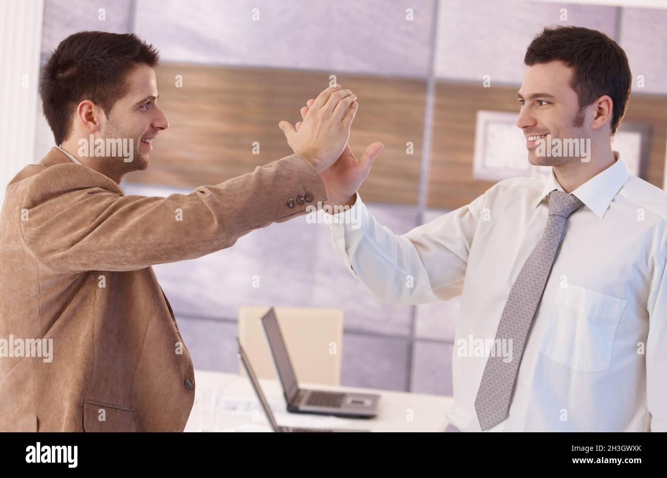 Young businessman celebrating success smiling Stock Photo - Alamy