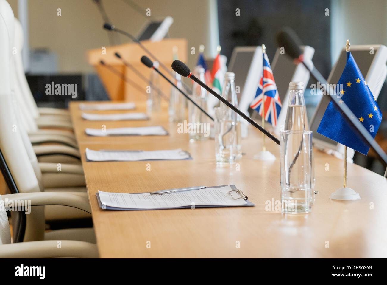 Political reports in clipboards placed on conference table with glass ...