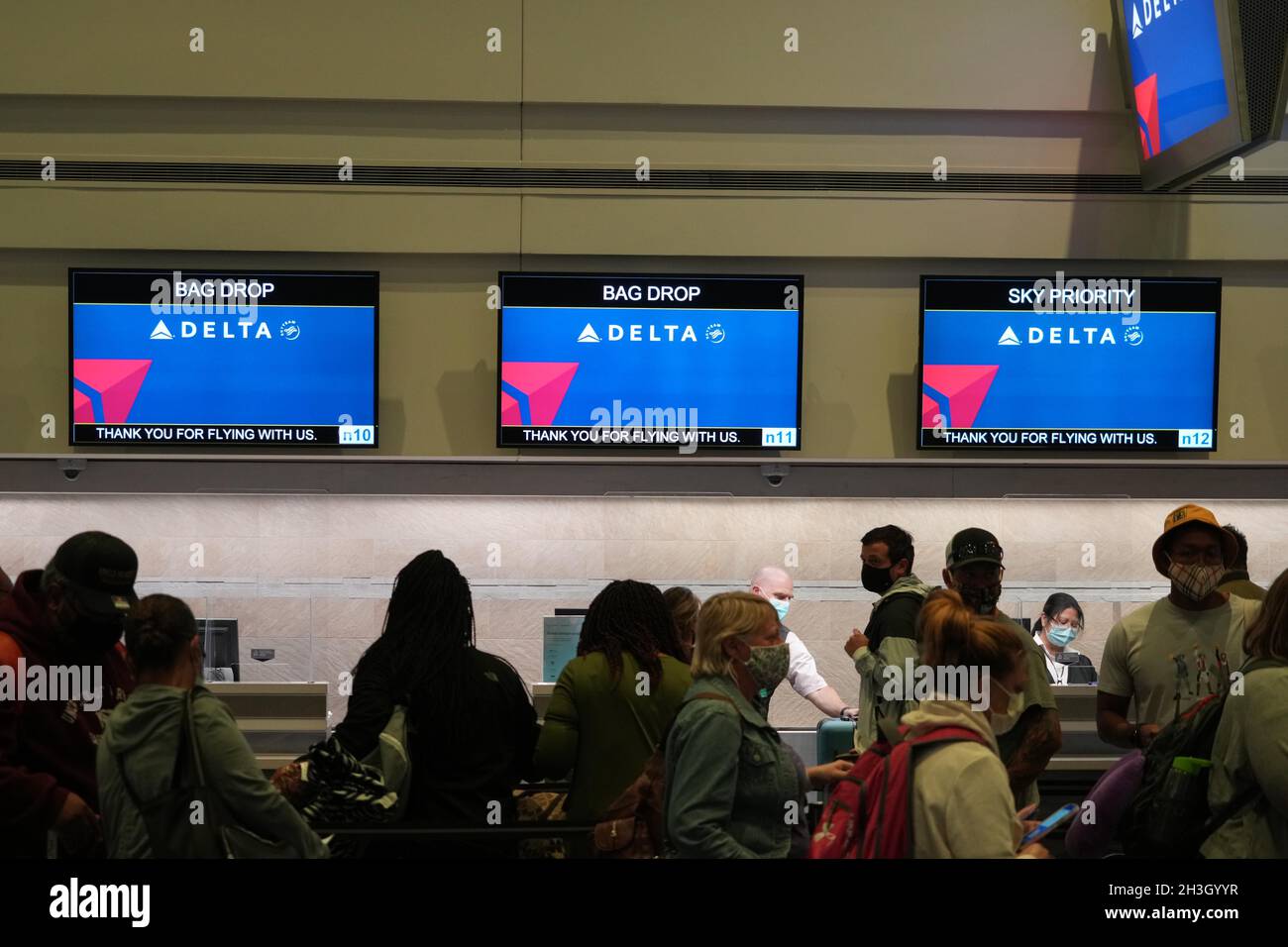 Passengers at Delta Airlines ticket baggage drop counter at the ...