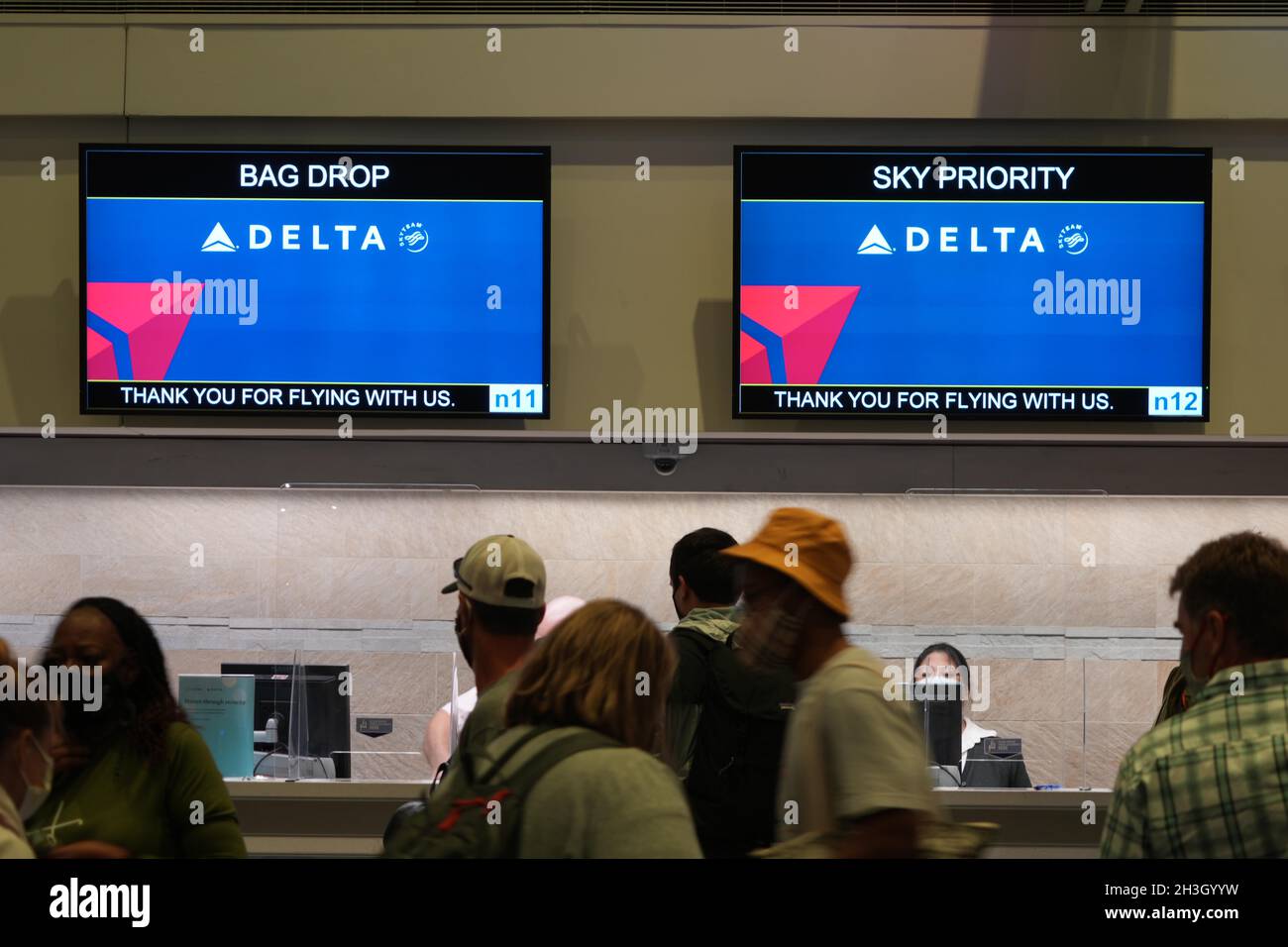 Passengers at Delta Airlines ticket baggage drop counter at the ...