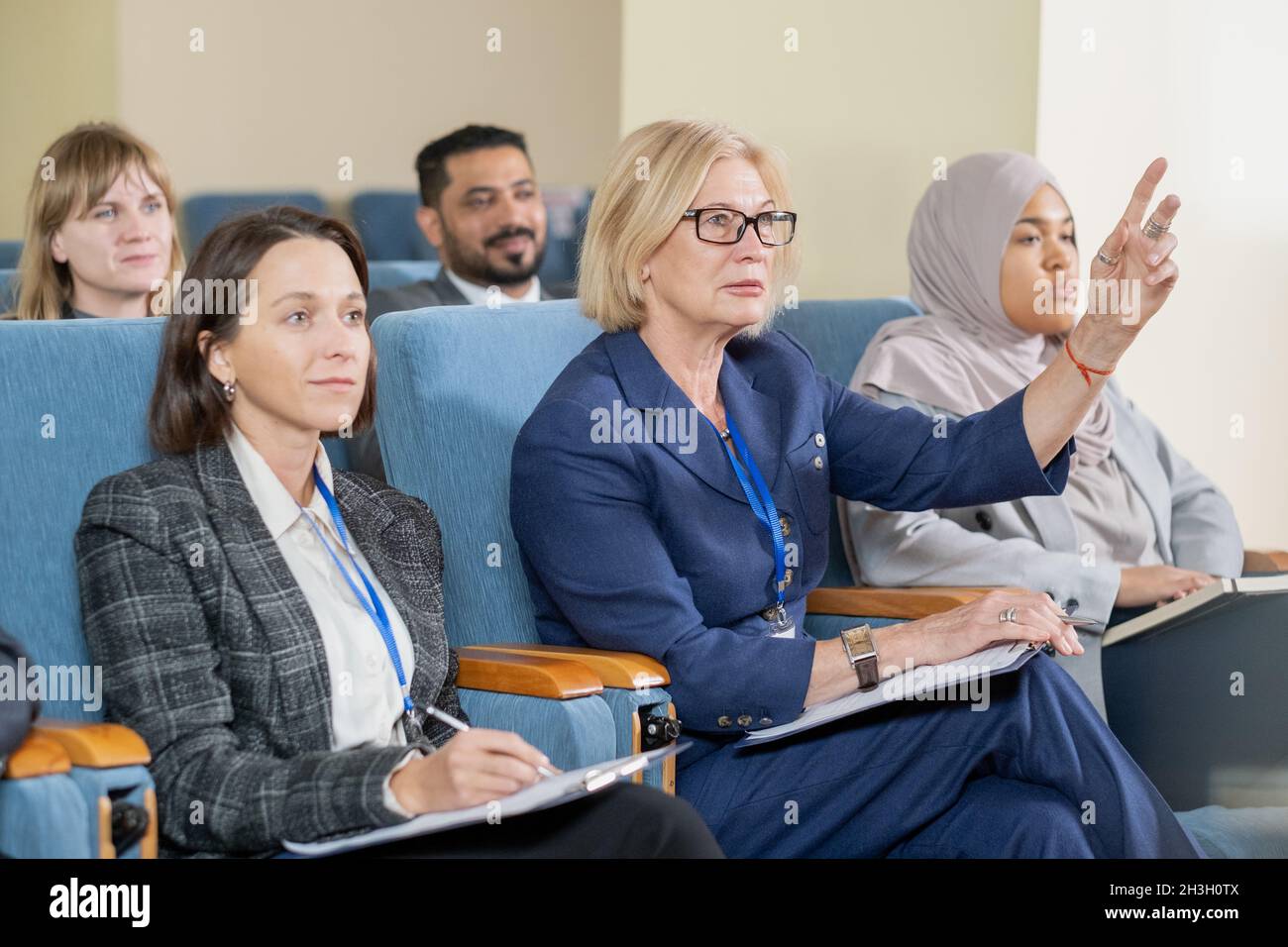 Woman raising hand question hi-res stock photography and images - Alamy