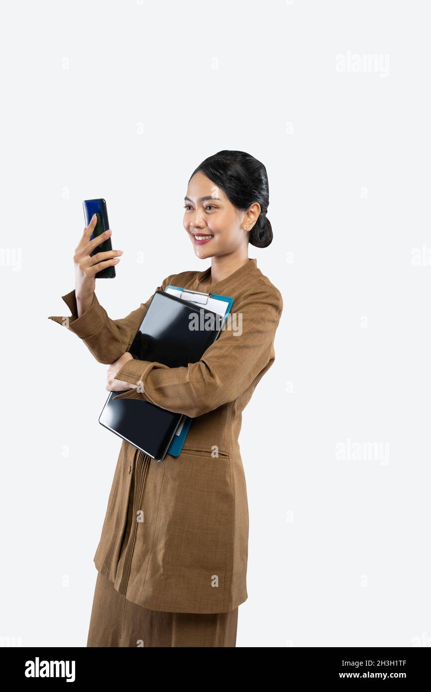 Female teacher in uniform makes a call using phone while carrying ...