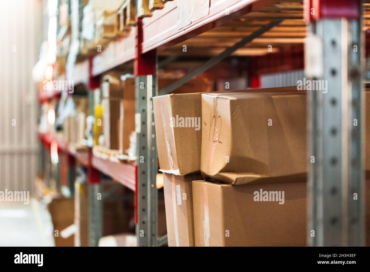 Modern warehouse shelves with pile of cardboard boxes Stock Photo - Alamy