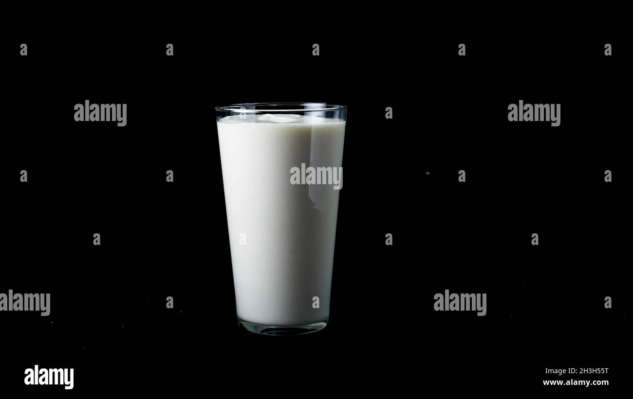 Close-up in glass pour white yogurt. Frame. In transparent large glass ...