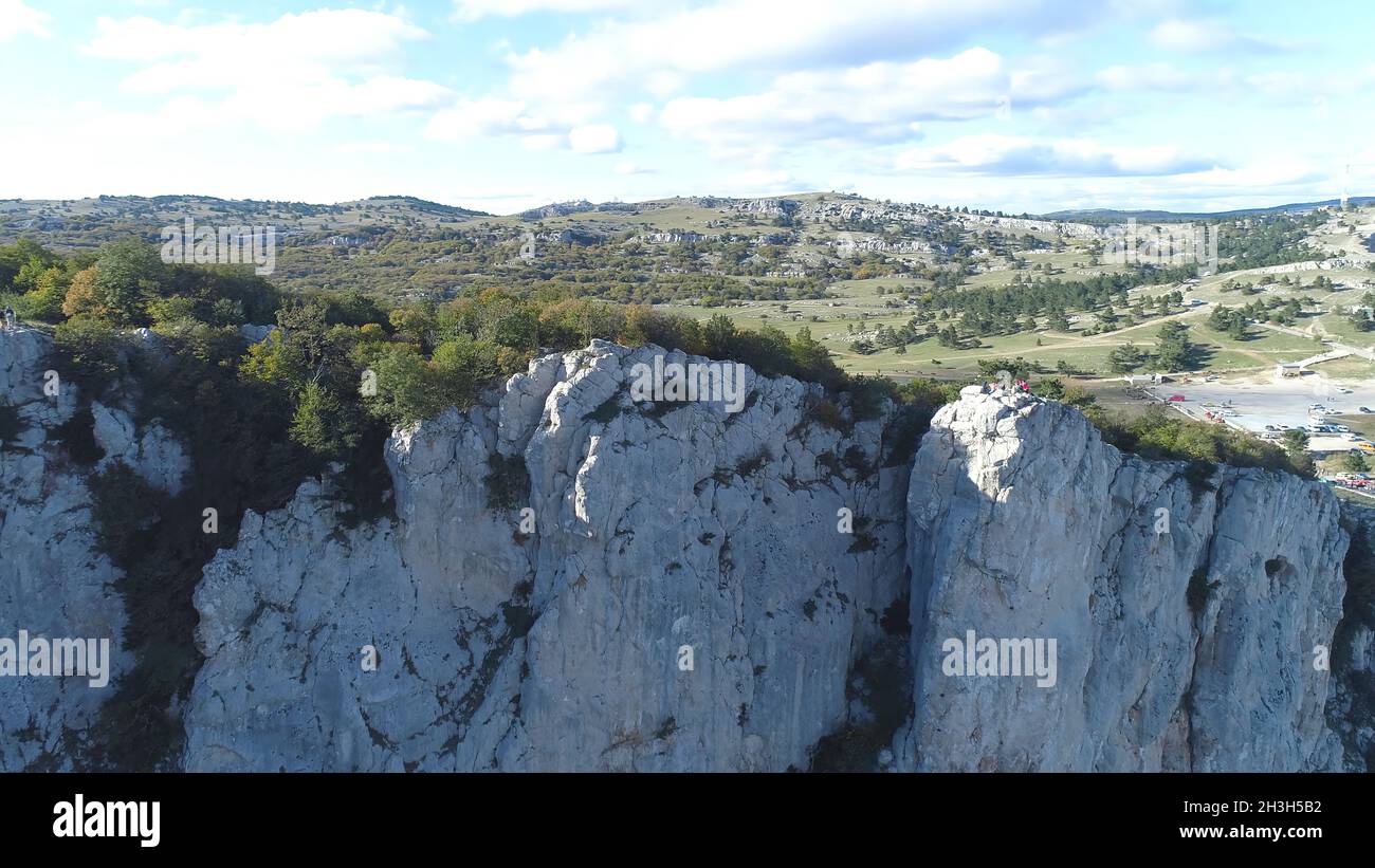 Top view of tourists over mountain abyss. Shot. Fascinating view of ...
