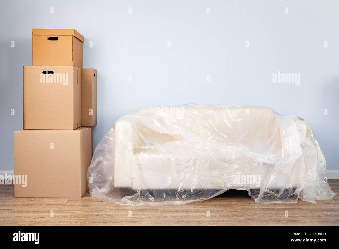 Packed household stuff in boxes and packed sofa for moving Stock Photo ...