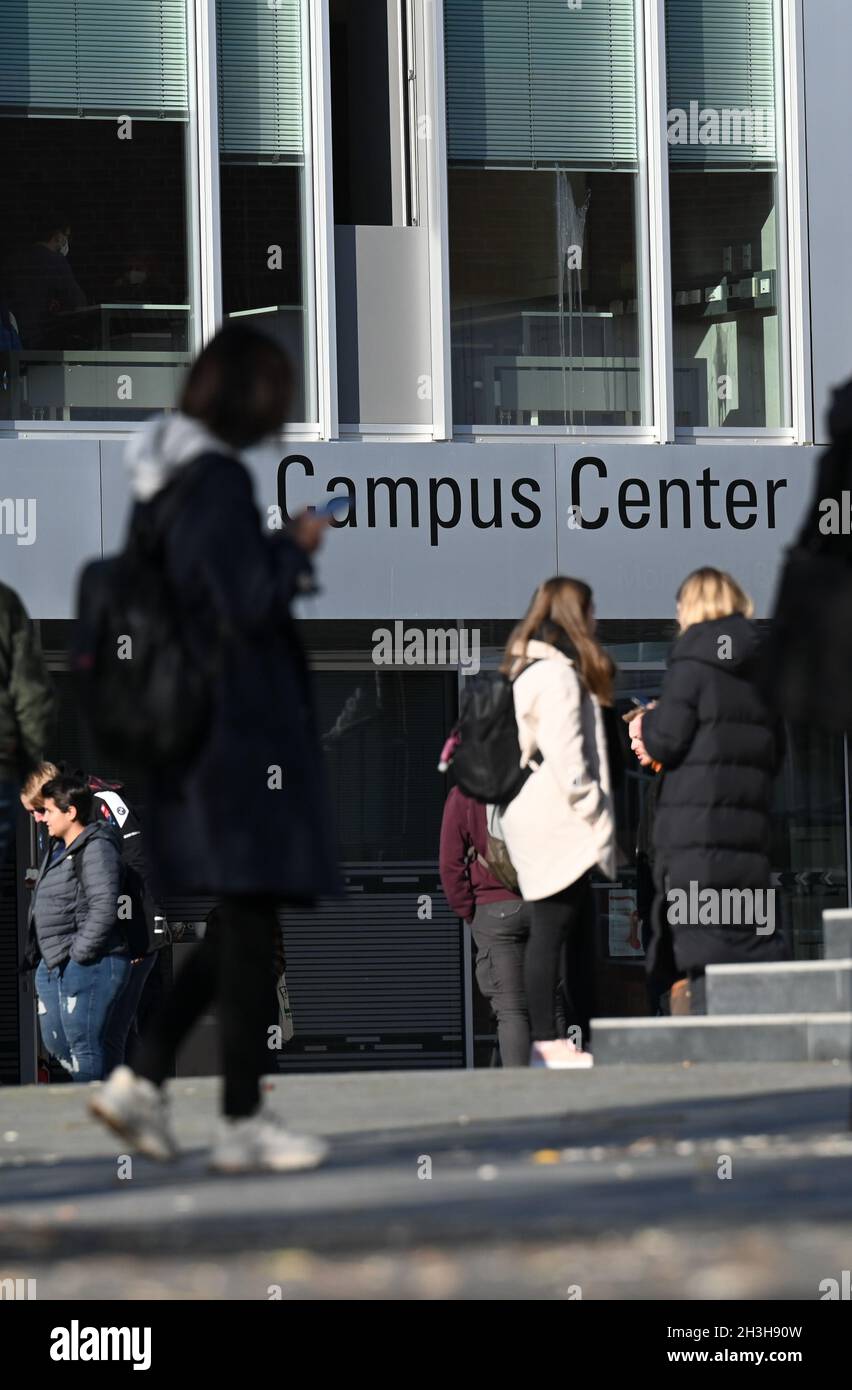 Kassel, Germany. 25th Oct, 2021. Students stand in front of the Campus ...