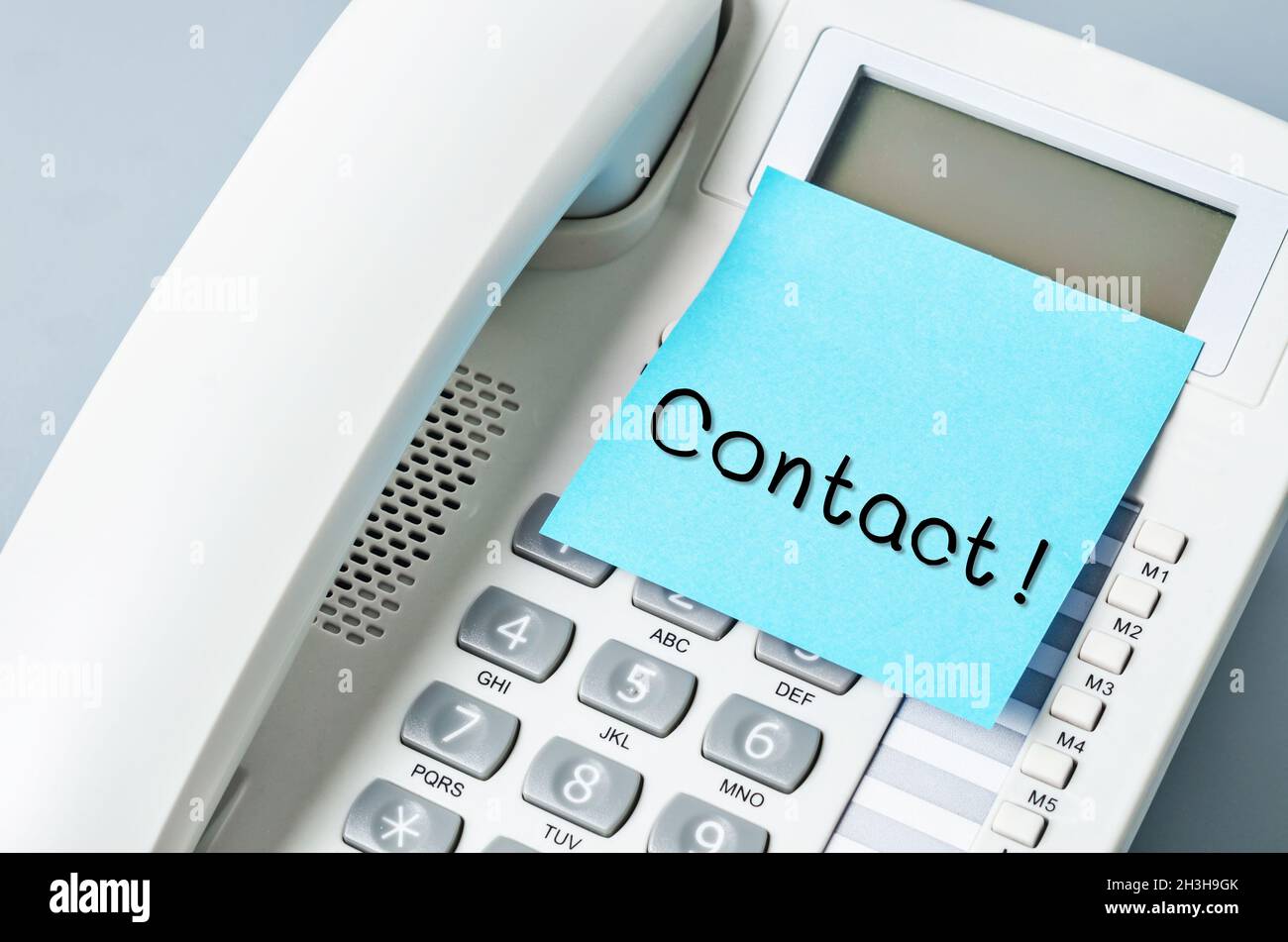 Handwritten CONTACT message on sticky note attach to IP phone Stock ...