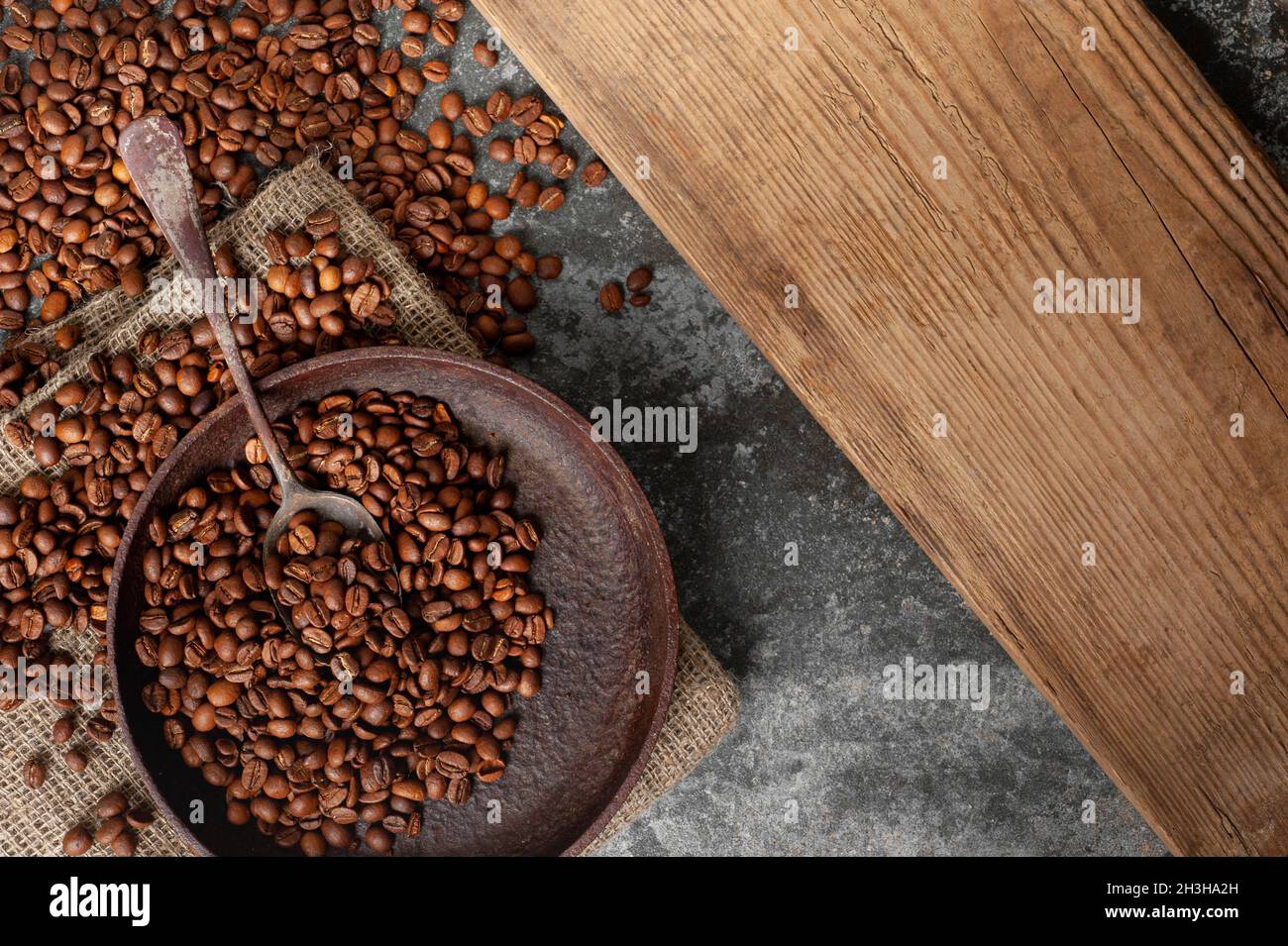 roasted coffee beans in an old vintage frying pan top shot. copy space ...