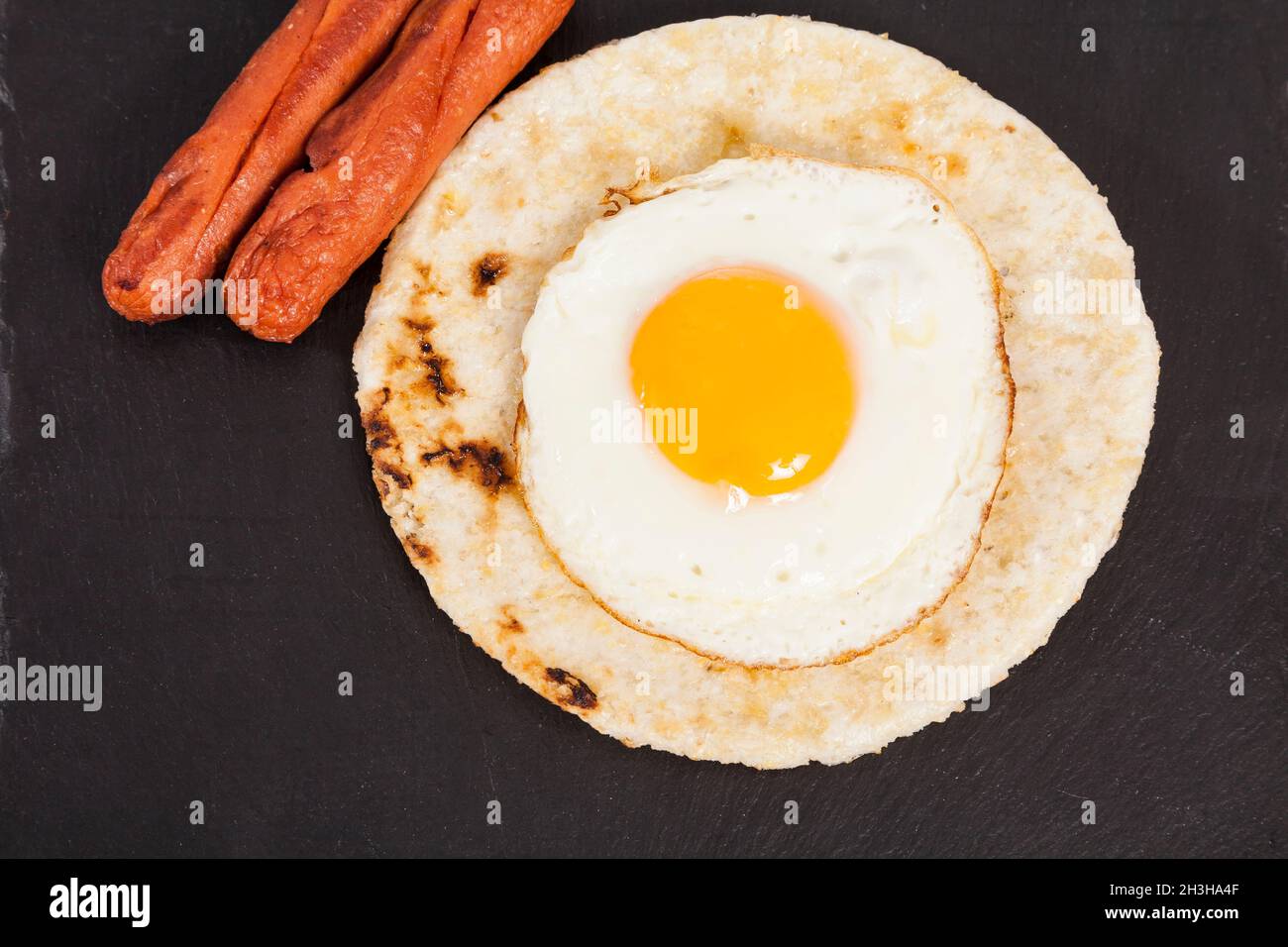 Traditional Latin American Breakfast; White Corn Arepa with Fried Egg ...