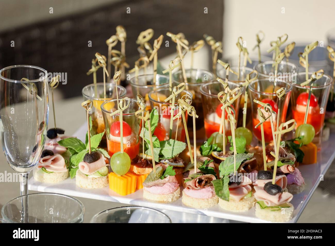 Appetizers on the white plate on a buffet table. High quality photo ...