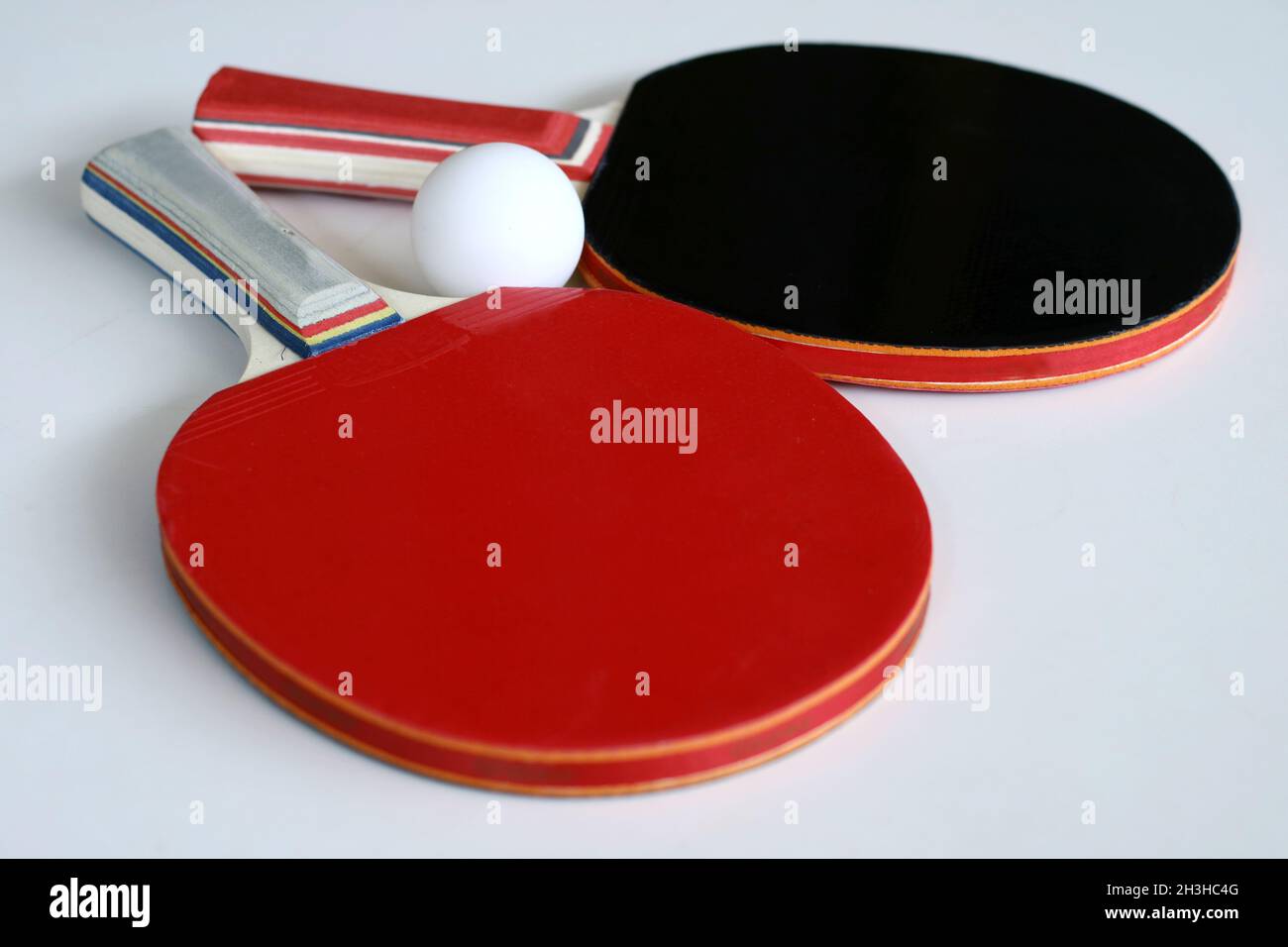 Table tennis paddle and ball on white background Stock Photo - Alamy